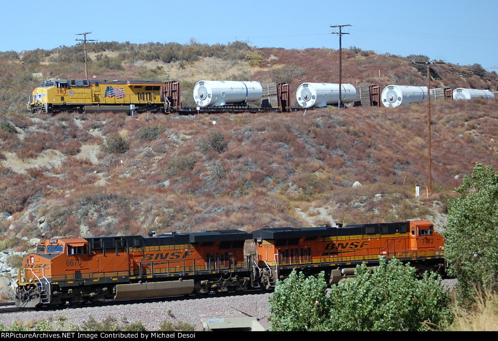 UP 7913 leads a westbound windmill? train on top as BNSF 6670 leads another westbound on the ...